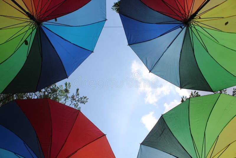 Four Umbrellas Hanging Against the Blue Sky Stock Photo - Image of four ...