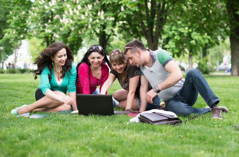 Four University Students Comparing Their Notes Stock Photo - Image of ...