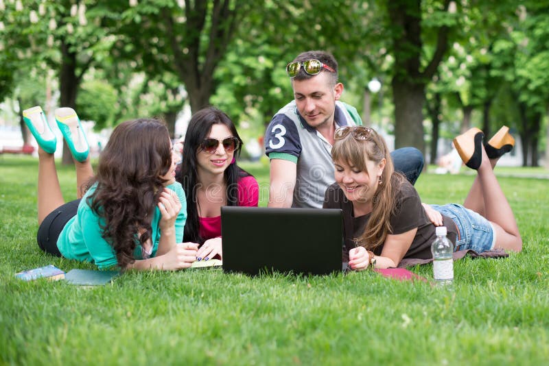 Four University Students Comparing Their Notes Stock Photo - Image of ...