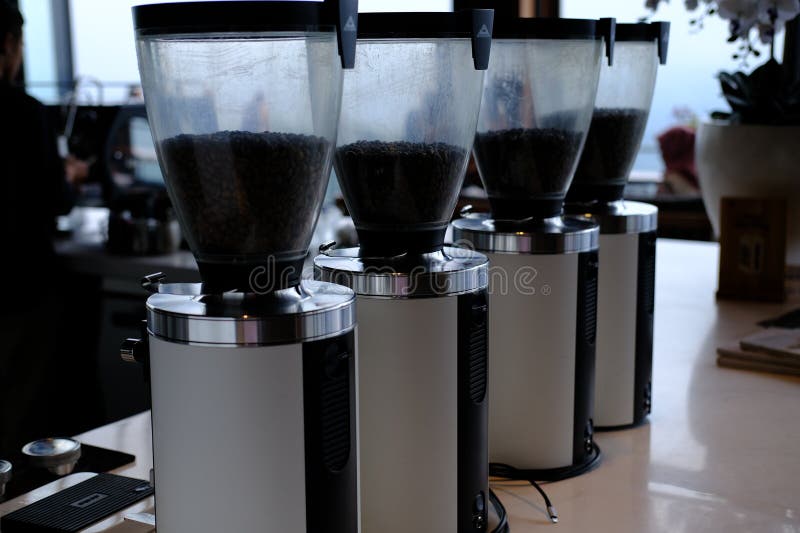 Four White Coffee Grinders on a Table Stock Photo - Image of countertop ...