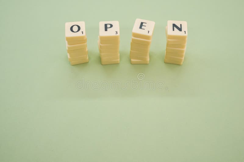 Four White Letter Block Stacks Forming the Word OPEN on a Green ...