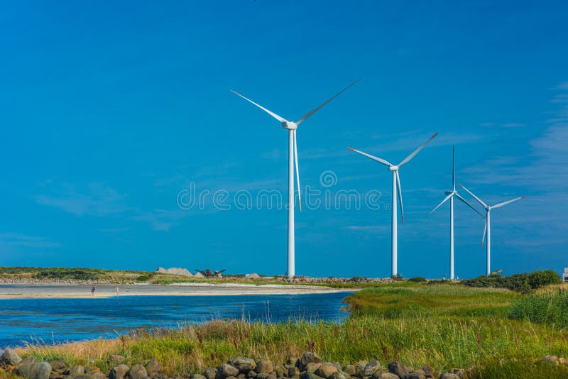 Four Wind Turbines by a Bay and a Small Beach Stock Image - Image of ...