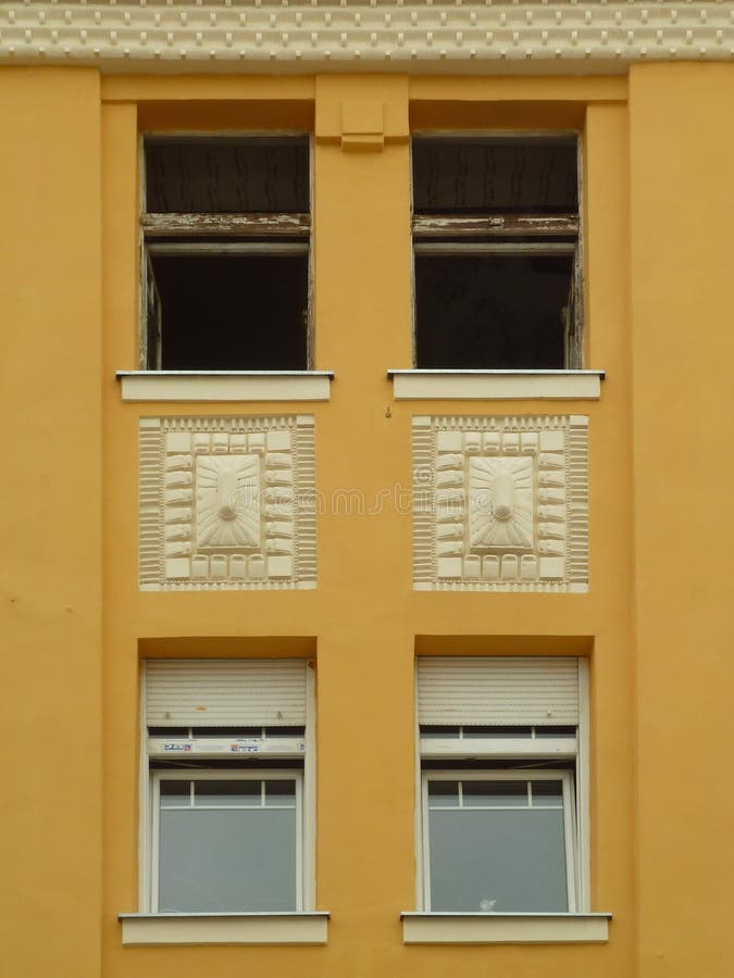 Four Windows on Yellow Wall Stock Image - Image of concrete, urban ...