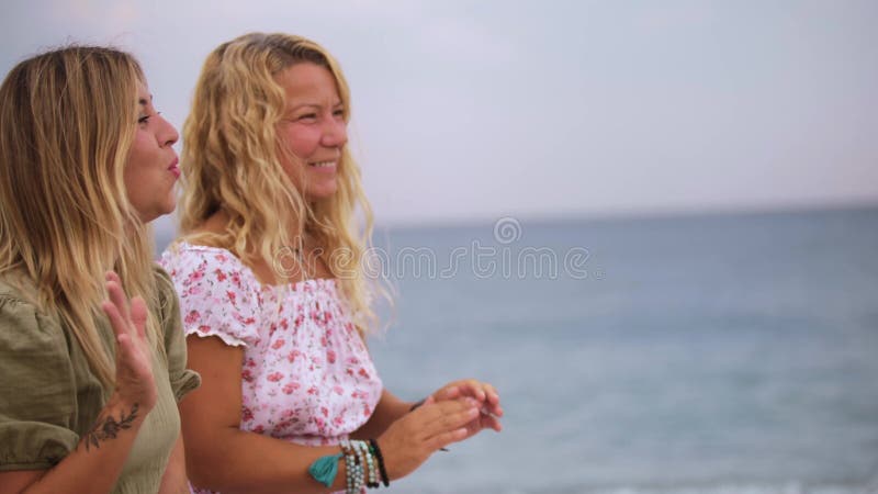 Four Women Having Chilling on the Beach - Looking at the Pictures on ...