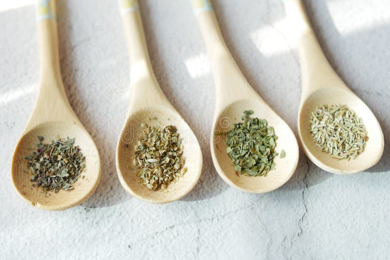 Four Wooden Spoons Holding Various Spices on a Table Stock Photo ...