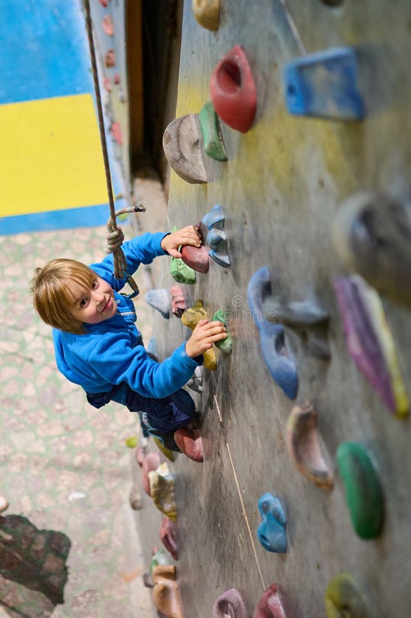 Four Year Old Boy Climbs the Climbing Wall in the Hall. Stock Image ...
