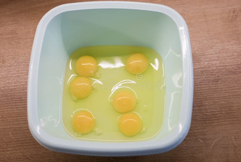 Four Yellow Eggs in Plastic Bowl Stock Photo - Image of ingredient ...
