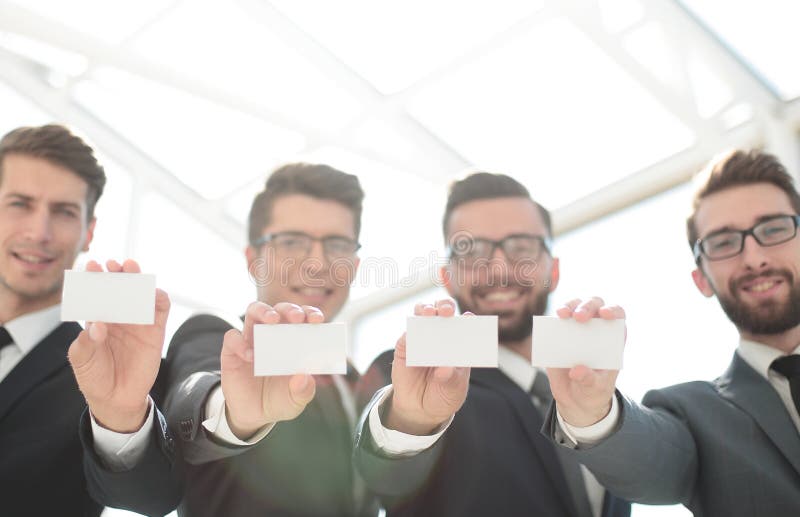 Four Young Business People Showing Their Business Card Stock Photo ...