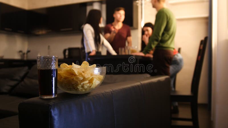Four Young People Standing on Kitchen and Talking. Bowl Filled with ...