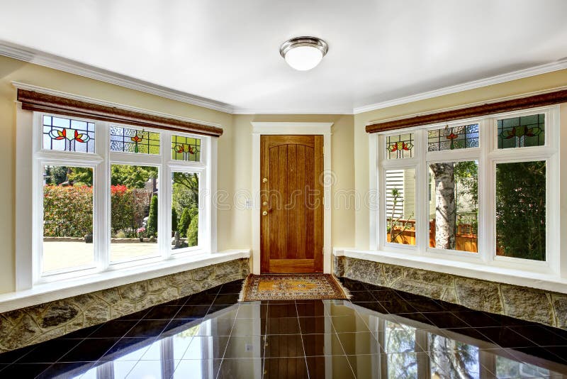 Foyer with Black Shiny Tile Floor and Stone Trim Under the Windows ...