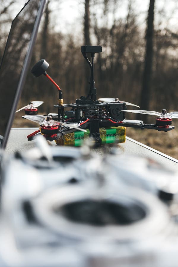 FPV Drone Lies on the Table Near the Laptop and Control Panel. Stock ...