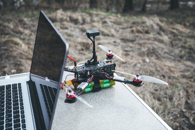FPV Drone Lies on the Table Near the Laptop and Control Panel. Stock ...