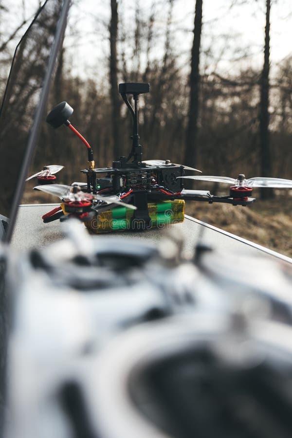 FPV Drone Lies on the Table Near the Laptop and Control Panel. Stock ...