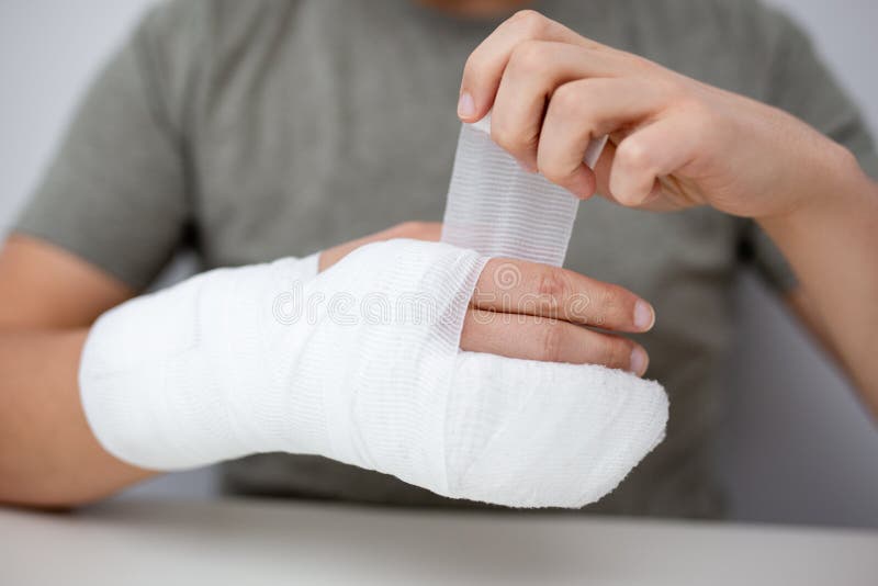 Fracture and First Aid Concept - Close Up of Man Bandaging His Hand ...