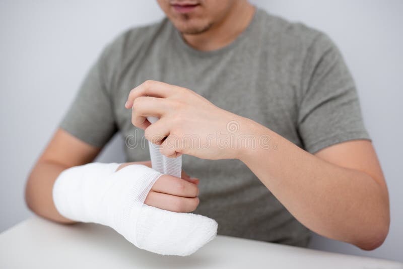 Fracture and First Aid Concept - Close Up of Man Bandaging His Hand ...