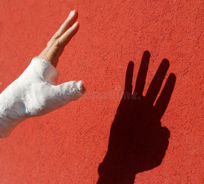 Fractured and Cast Hand and the Shadow on the Red Wall Stock Image ...