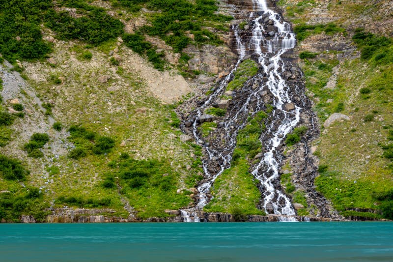 Fracturing Water Fall Drops into Lake Frances in Glacier Stock Image ...