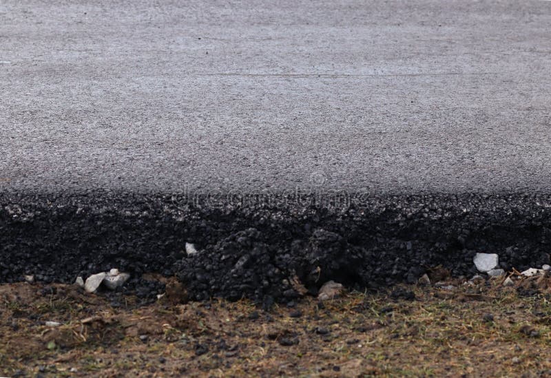 Fragment of Freshly Laid Black Asphalt on a Cushion of Rubble. Modern ...