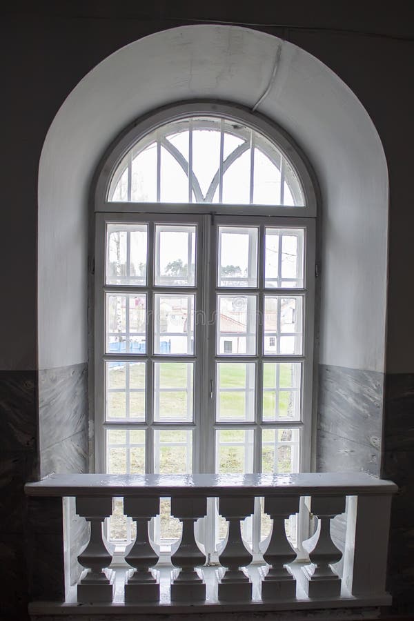 A Fragment of a High Semicircular Arched Window with a Frame in a Dark ...