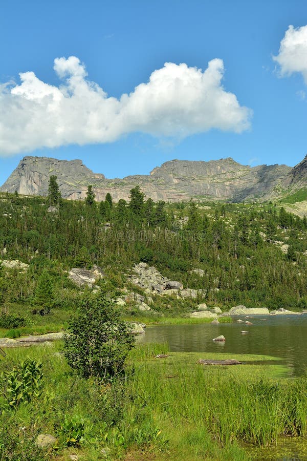 A Fragment of a Lake Surrounded by Mountain Taiga Against the Backdrop ...