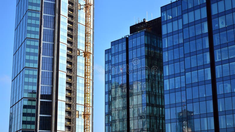 Blue Curtain Wall Made of Toned Glass and Steel Constructions Under ...