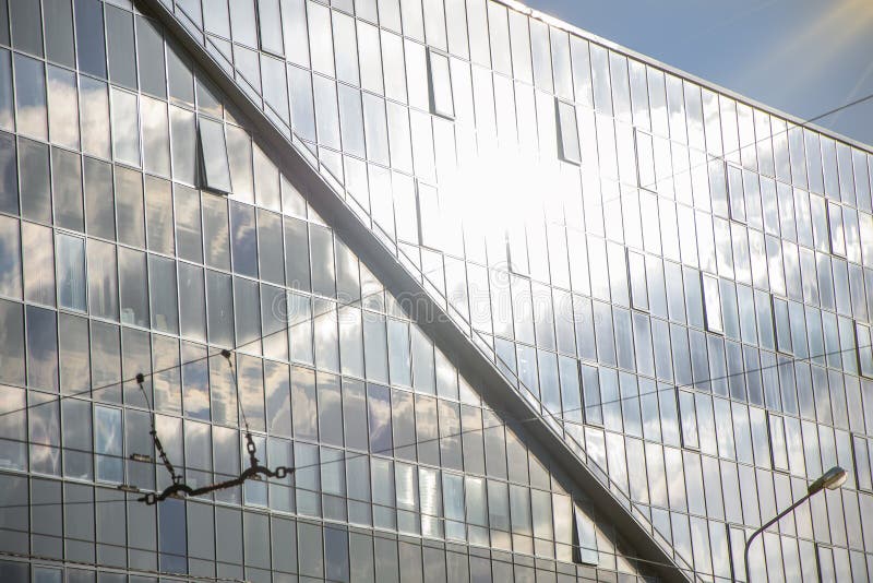 A Fragment of a Modern Building with Windows that Reflect the Sky and ...