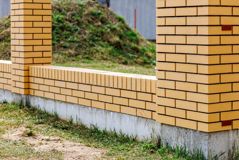 Fragment of a Modern Fence Lined with Decorative Bricks in the Old ...