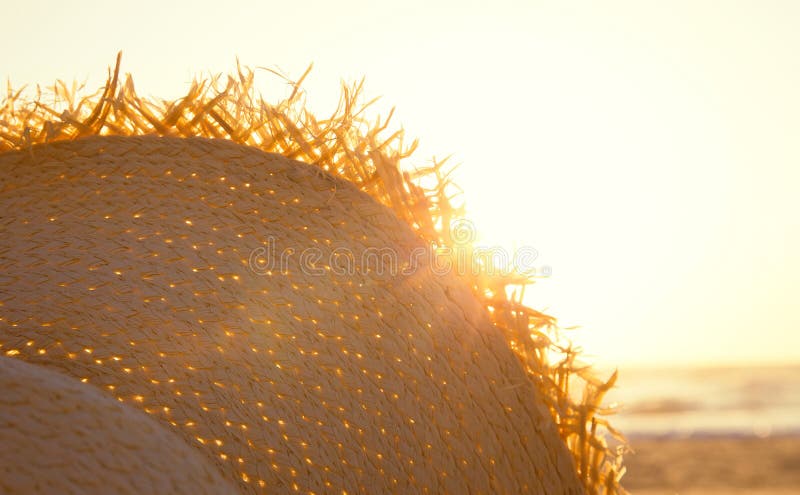Fragment of a Straw Hat in Sunset Light on the Beach. Vacation Theme ...