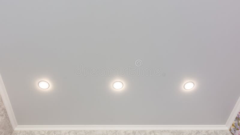 Fragment of the Stretch Ceiling with Three Spotlights in a Row Stock ...