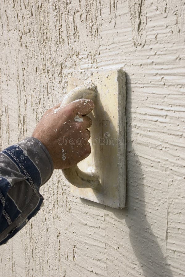Hand of Plasterer Holds an Old Putty Knife and Scrapes Concrete ...