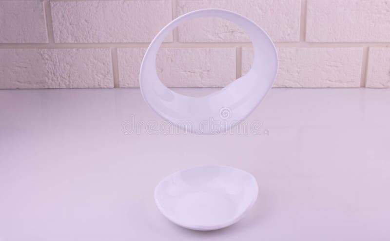 Fragments of a Broken White Plate Flying on a White Background Stock ...
