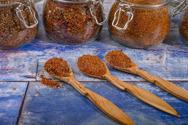 Fragrant Spices in Wooden Spoons and Glass Jars on the Table Stock ...