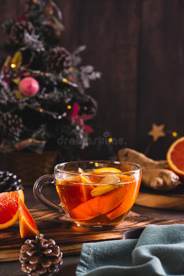 Fragrant Tea with Pieces of Orange and Ginger in a Cup on the Table ...