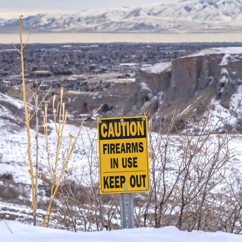 Frame Caution Firearms in Use Keep Out Sign on a Mountain Covered with ...