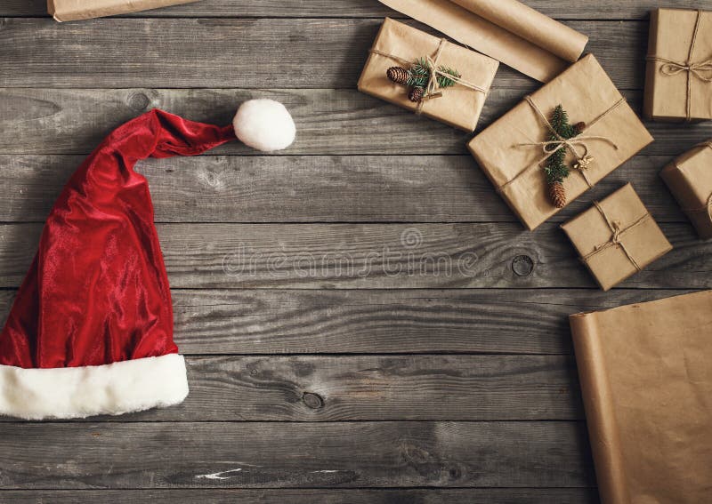 Frame of Christmas Present and Santa Hat on Wooden Table Stock Photo ...