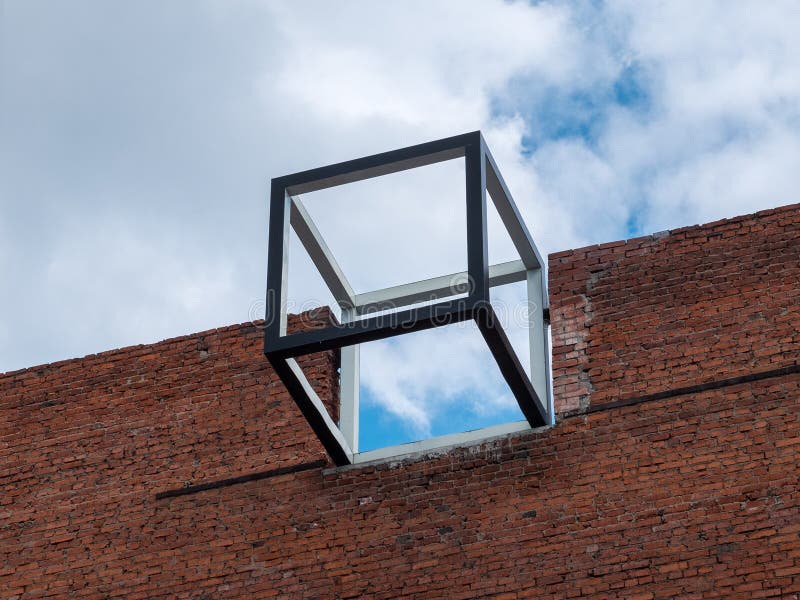 A Frame Cube Installed on the Roof of a Brick Building. Stock Image ...
