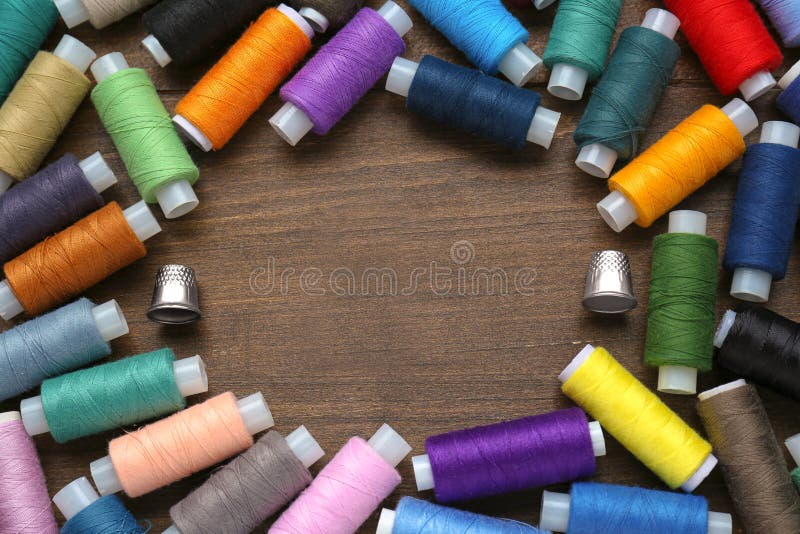 Frame Made of Colorful Threads and Sewing Thimbles on Wooden Table ...