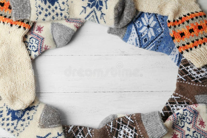 Frame Made with Different Knitted Socks on White Wooden Background ...