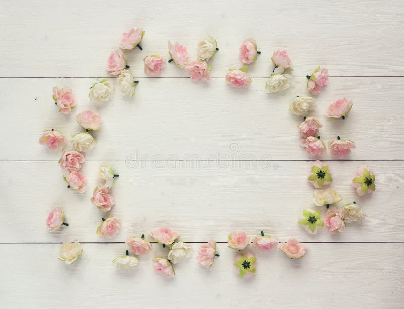 Frame of Pink Small Roses on a White Wooden Background with Empty Space ...