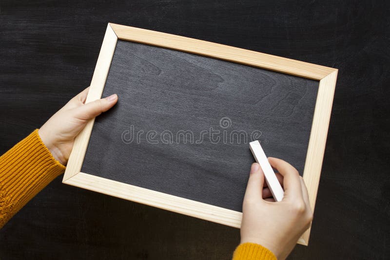 A Framed Chalkboard in the Hands of a Girl. Hand with Chalk Stock Image ...