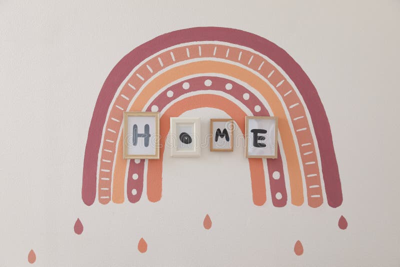 Frames with Word Home and Painting of Rainbow on White Wall Indoors ...