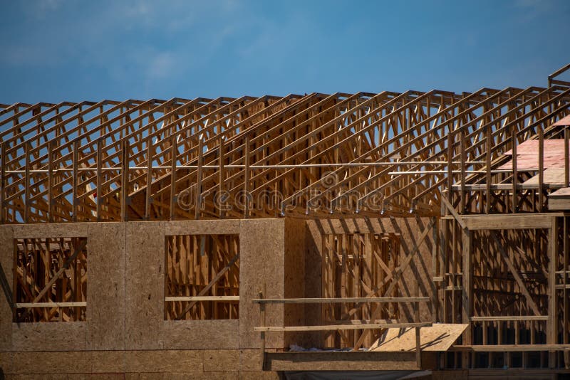 Framing and Roofing. Timber Frame of a House Against a Blue Sky. the ...