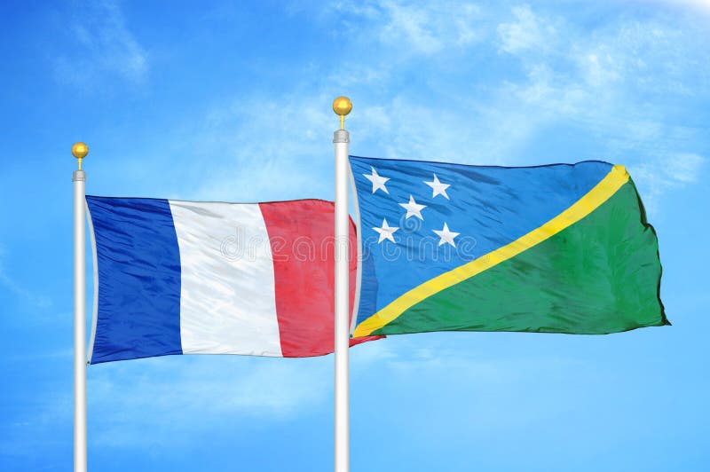 France and Solomon Islands Two Flags on Flagpoles and Blue Cloudy Sky ...