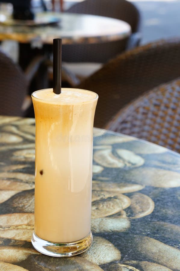 White Frappe Coffee Glass with Iced Drink on a Dark Wooden Table in a ...