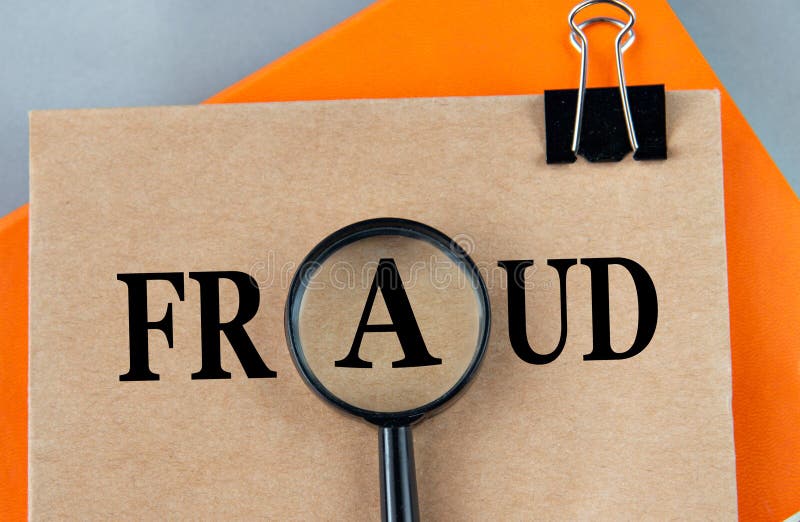FRAUD - Word on a Brown Sheet with a Magnifying Glass in the Center ...