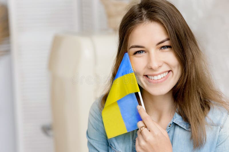 Free Smiling Girl Holding Ukrainian Flag In Her Hands Asking For Peace