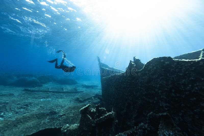 Freediver Swimming in Deep Sea and Exploring Ship Wreck Stock Image ...
