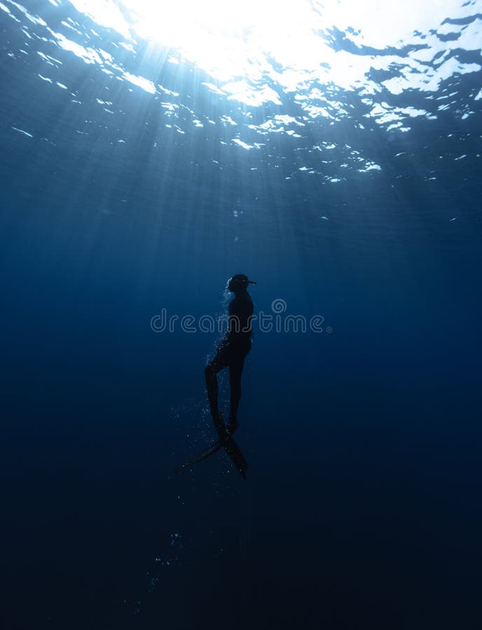 Freediver Swimming in Deep Sea with Sunrays Stock Image - Image of ...