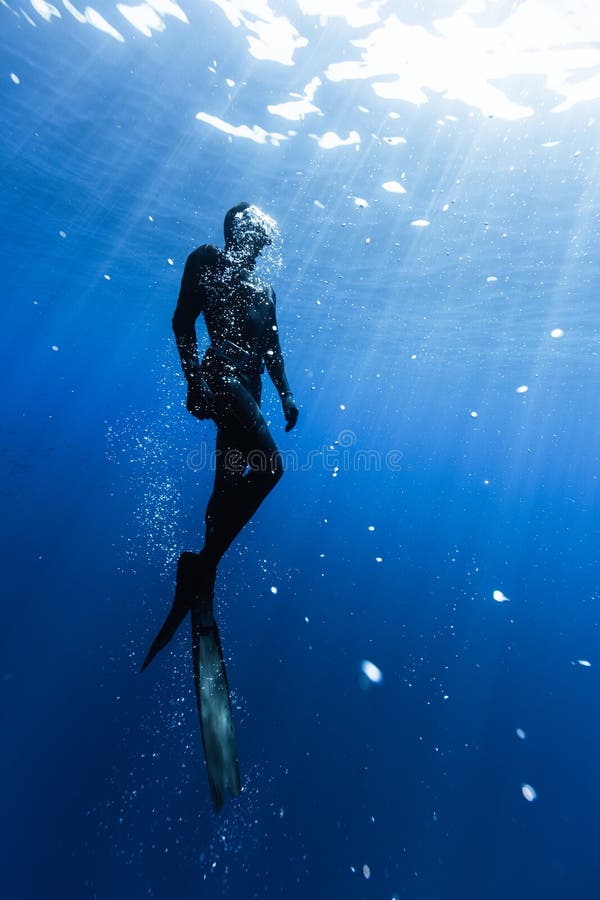 Freediver Swimming in Deep Sea with Sunrays Stock Image - Image of ...