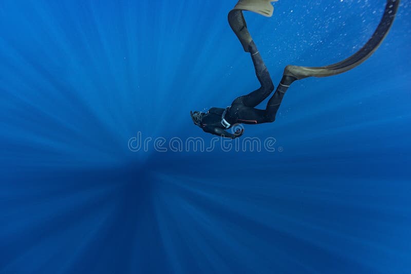 Freediver Swimming in Deep Sea with Sunrays Stock Photo - Image of ...
